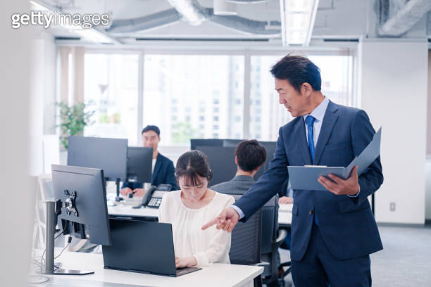 Young female employee being reprimanded by her boss in her office ...