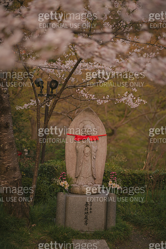Kiyomizu-dera Temple in Kyoto, Stone statue with a red cloth surrounded ...