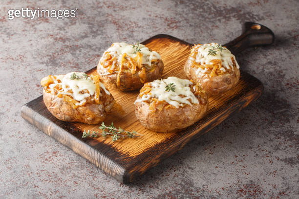 Whole baked jacket potatoes stuffed with French onions and Gruyere ...