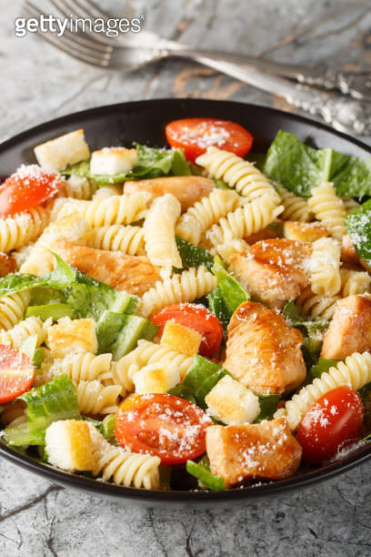 Delicious Caesar salad pasta with chicken, romaine lettuce, parmesan ...