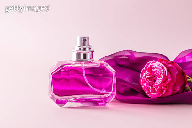 A chic bottle of women's perfume and a delicate chiffon scarf with a ...