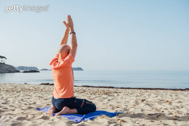 Calm man sitting in Seiza position, doing deep breathing exercises and ...