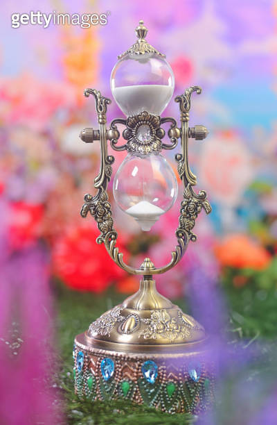 A Golden Antique Victorian Countdown Sand Timer in a Beautiful Summer ...