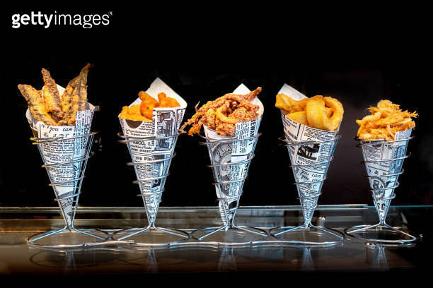 Food cones with fish and seafood snacks at a market in Spain. Spanish ...