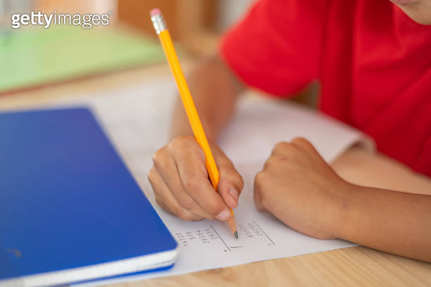 Close-Up Of A Primary School Child's Hand Doing Math Homework. Back To ...