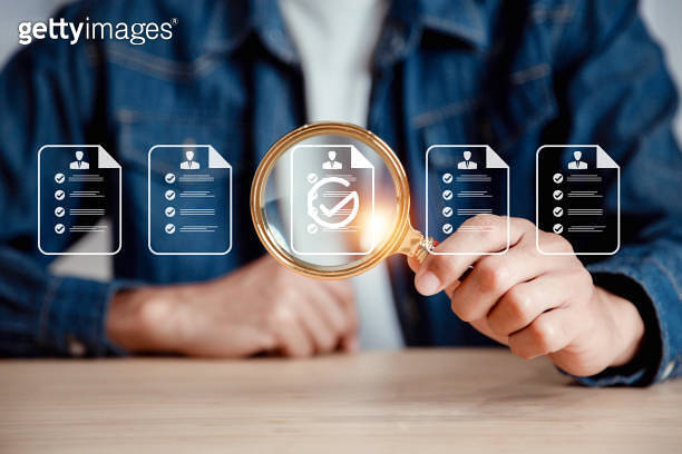 Businessman use magnifying glass focus to human icons for customer ...