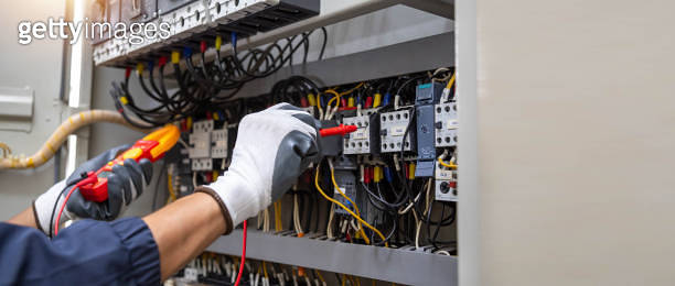 Checking the electrical system, an electrician is using an electric ...