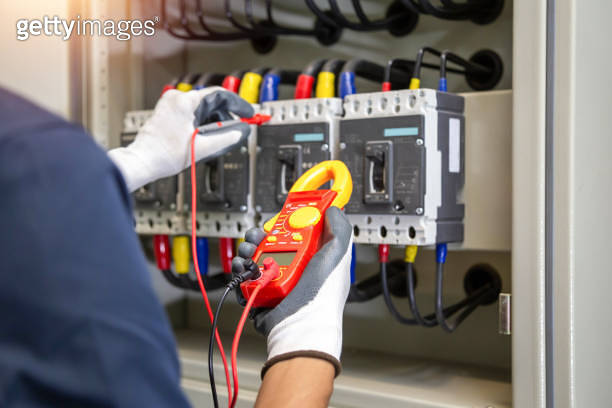 Electricians use electric meters to check equipment in electrical ...