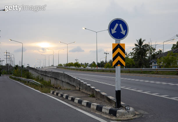 A sign indicating a traffic lane on the route before the bridge while ...