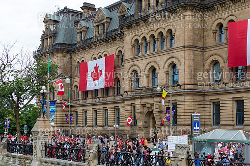 Canada Day in Ottawa. Canadian flags on buildings and walking people in ...