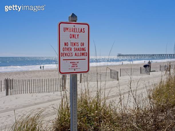 Unusual umbrellas only sign prohibiting tents along the famous Myrtle ...