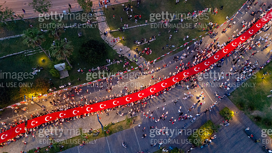 Crowd of Turkish people carrying a long Turkish flag on a National day ...