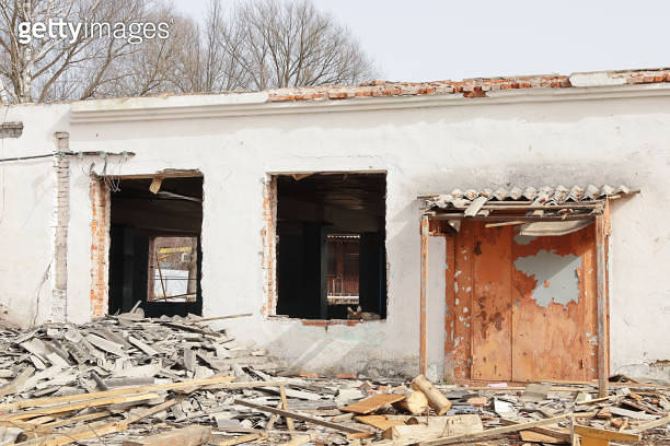 Old ruined house with no windows and collapsed roof, Film grain effect ...
