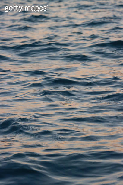 Full frame image of sea water surface level, sunlight glistening on ...