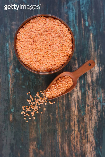 Image of pile of split red lentils (lal masoor dal) in orange-brown ...