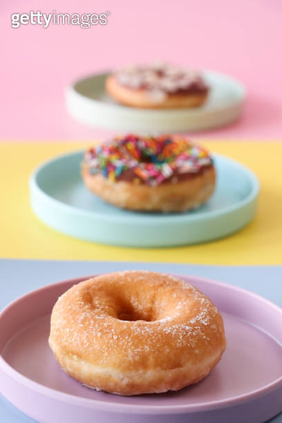 Close-up image of column of alternating plain and chocolate glazed ring ...