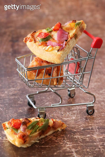 Close-up image of pizza slices in miniature, model shopping trolley ...