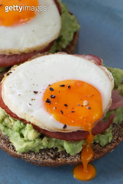 Full frames image of breakfast of wholemeal, toasted bagel topped with ...