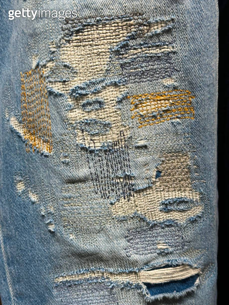 Full frame image of bleached, pre-frayed blue denim jeans, ripped denim ...