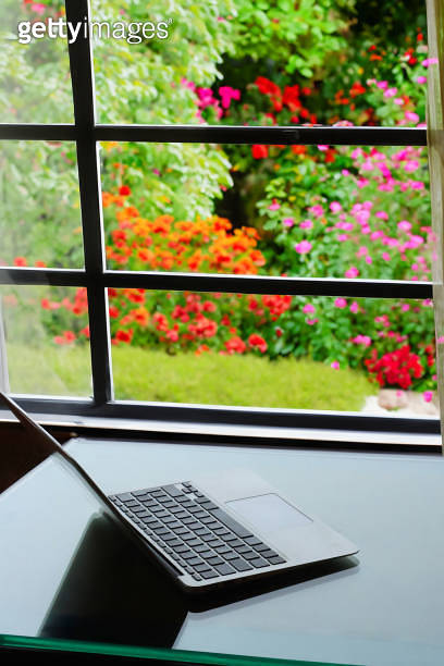 Close-up image of laptop on glass topped home office work desk, located ...