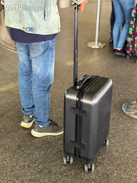 Close-up image of unrecognisable passenger wearing denim jacket and ...