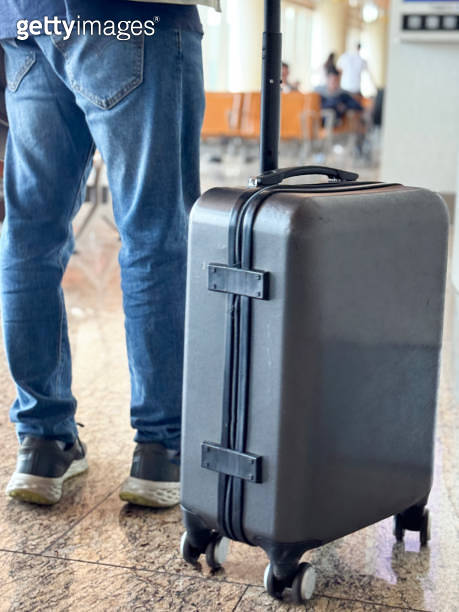 Close-up image of unrecognisable passenger wearing denim jacket and ...