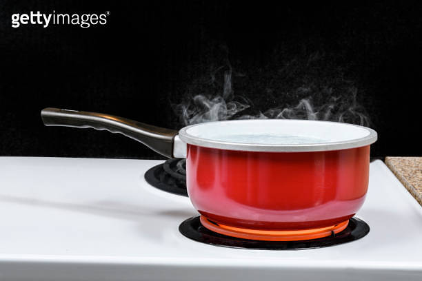 Red Pot of Boiling Water On Stove Top With Black Background 이미지 ...