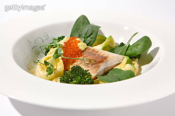 Cod Fillet with Red Caviar and Zucchini and Broccoli Garnish on White ...