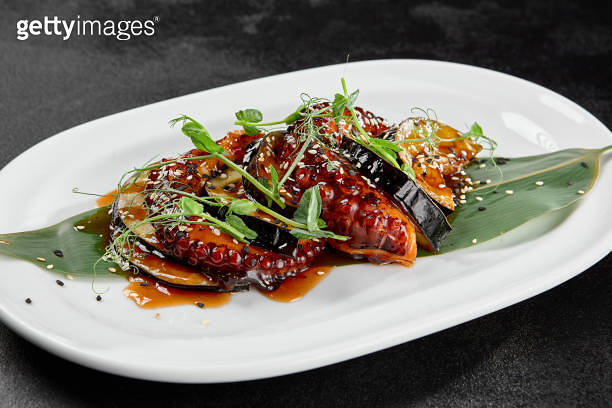 Delicatessen appetizer - grilled octopus with eggplant in teriyaki ...