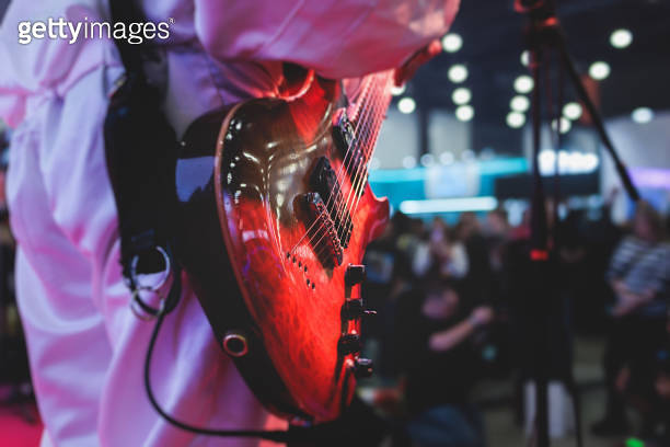 Concert view of an electric guitar player with vocalist and rock band ...