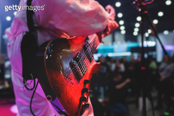 Concert view of an electric guitar player with vocalist and rock band ...