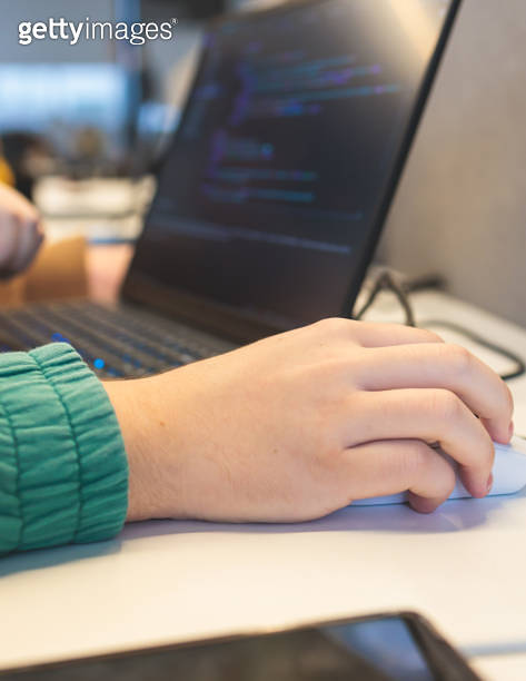 Software developer students in auditorium hall working on computer and ...