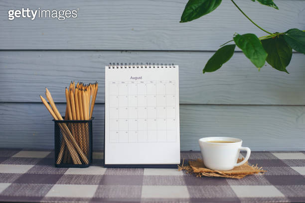 Desktop calendar and coffee placed on student wooden desk. 2024 ...
