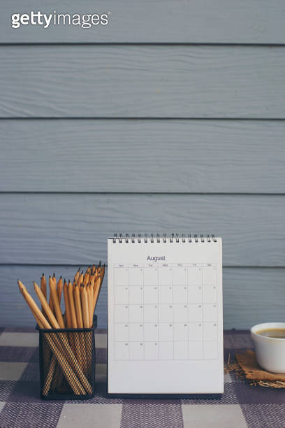 Desktop calendar and coffee placed on student wooden desk. 2024 ...