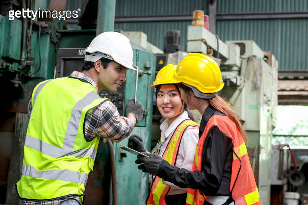 Group of male and female industrial engineer workers with helmet and ...