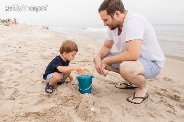 A 33-Year-Old Father Playing on the Beach with His 2-Year-Old Son ...
