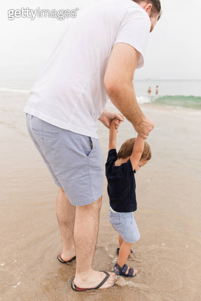 A 33-Year-Old Father Playing on the Beach with His 2-Year-Old Son ...