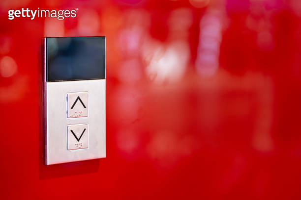 Elevator button on red wall. Elevator Button up and down direction with ...