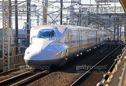 A Shinkansen N700 Series bullet train speeding through Mishima train ...