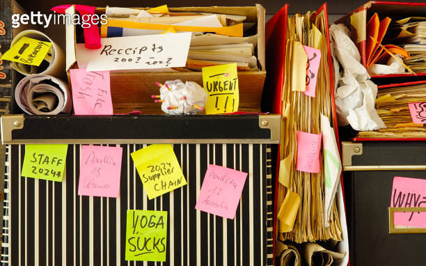 Messy file folder,sticky notes and old papers.Red tape, bureaucracy ...