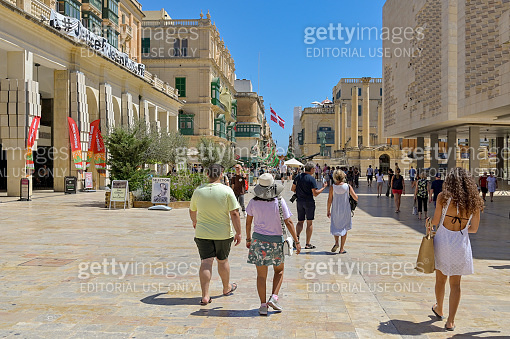 People walking past the Maltese Parliament building in Valletta, Malta ...
