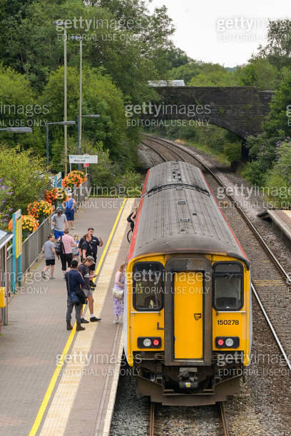 Passengers catching a train at the railway station at Pontyclun in ...