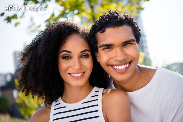 Photo of positive cheerful two people buddies smiling enjoying summer ...