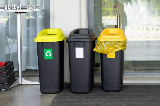 Colorful trash cans for sorting garbage. For plastic, glass, paper and ...