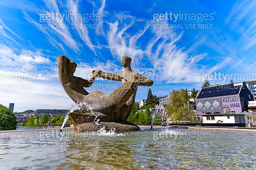 Fountain with nymph stone sculptures at public park of Swiss town at ...
