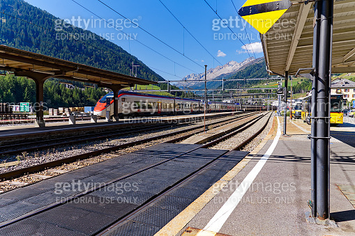 Diminishing perspective of train station of village of Airolo with ...