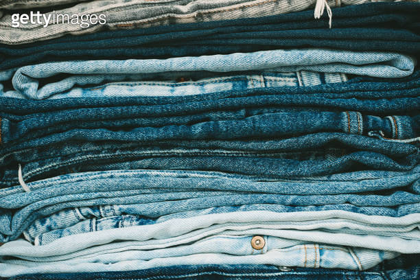 Stack of folded denim pants. Fashion, style, stock and store concept ...