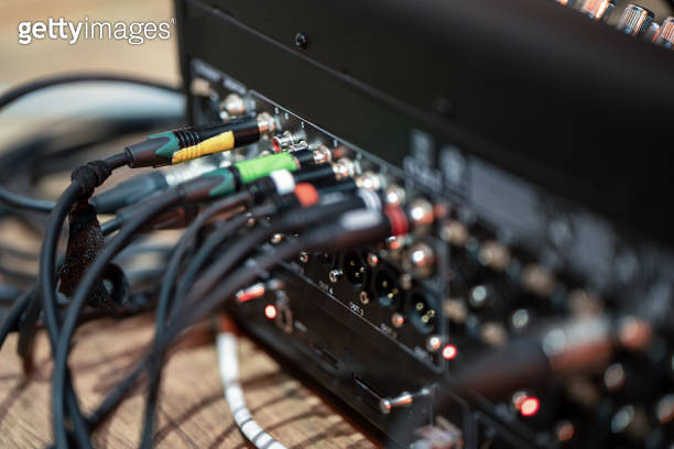 Audio cables connected to professional sound mixer, detailed connections and wiring. Modern ...