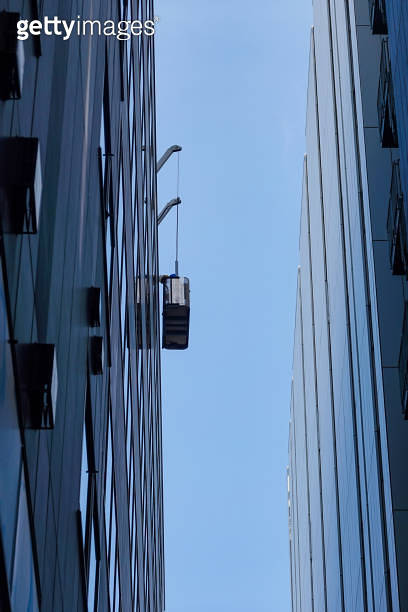 Cleaning windows of high-rise buildings in the valleys between ...