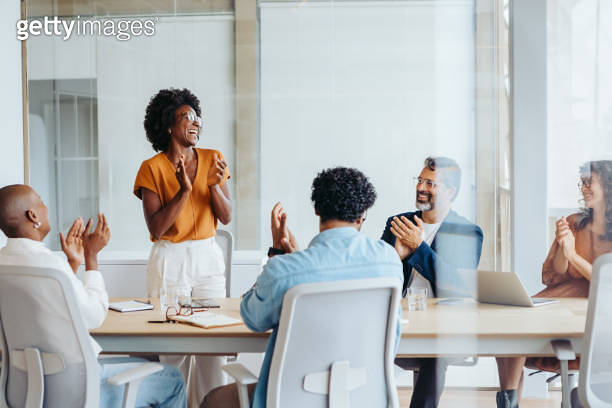 Successful business meeting with a creative team applauding their ...